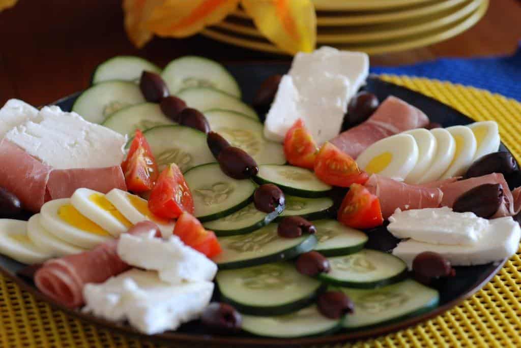 Meza (A plate of cucumbers, smoked meat, cheese, olives, tomatoes and ...